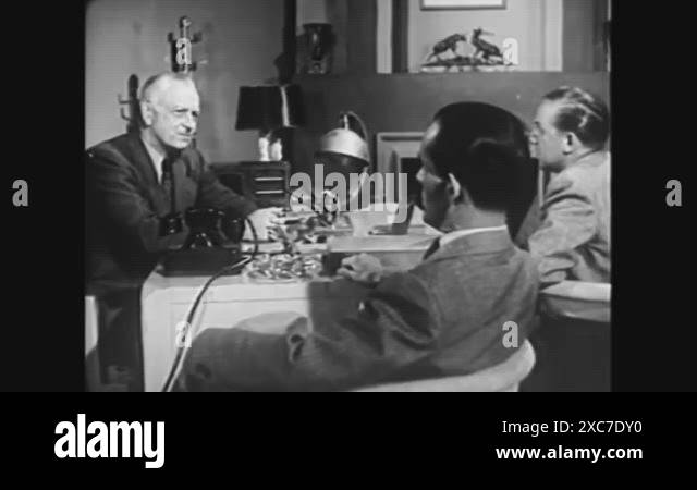 US - 1942 - in this war film, a man gives two other men in his office ...