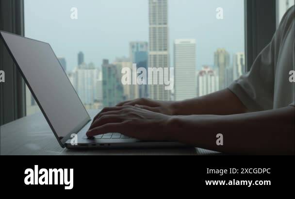 Seated at home office desk person programming typing keyboard coding ...