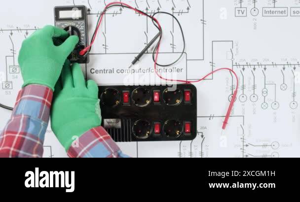 Technician tests voltage with multimeter and adds warning sign on ...