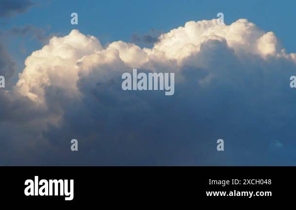 Beautiful yellow clouds in sky. Volumetric light effect. Sunrays are hidden behind approaching ...