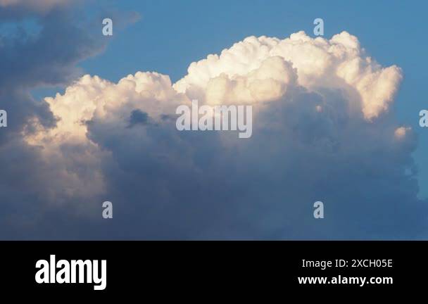 Beautiful yellow clouds in sky. Volumetric light effect. Sunrays are hidden behind approaching ...