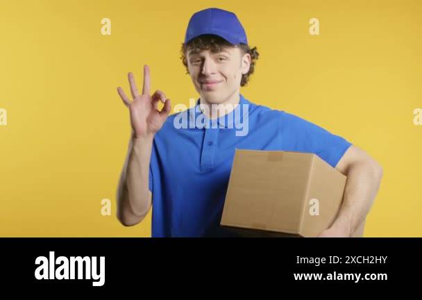 Positive postal courier man with hands sign OK, okay. Happy postman in ...
