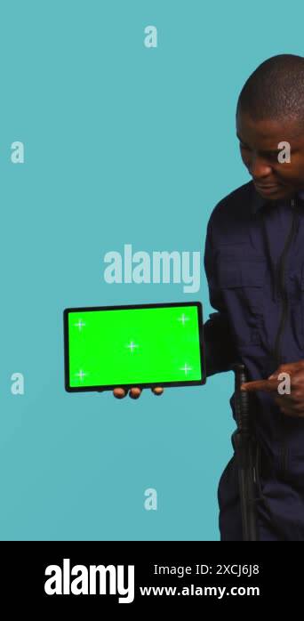 Vertical video Portrait of happy security staff member showing isolated ...