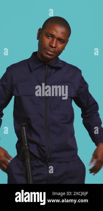 Vertical video Security guard doing thumbs down sign gesturing, denying ...