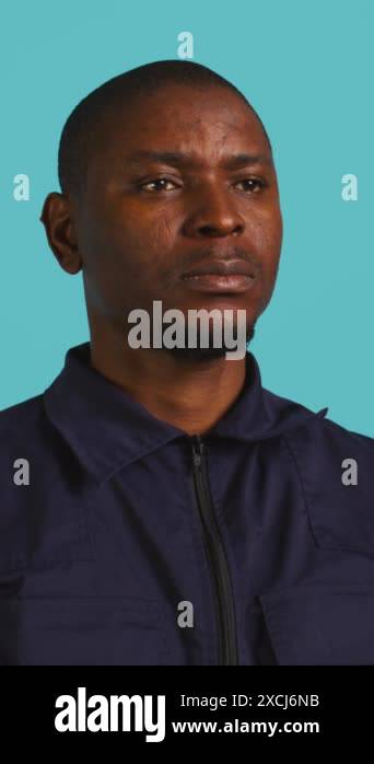 Vertical video Portrait of security job employee waving hand, being ...