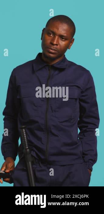 Vertical video Security guard preventing criminal activity turning on ...