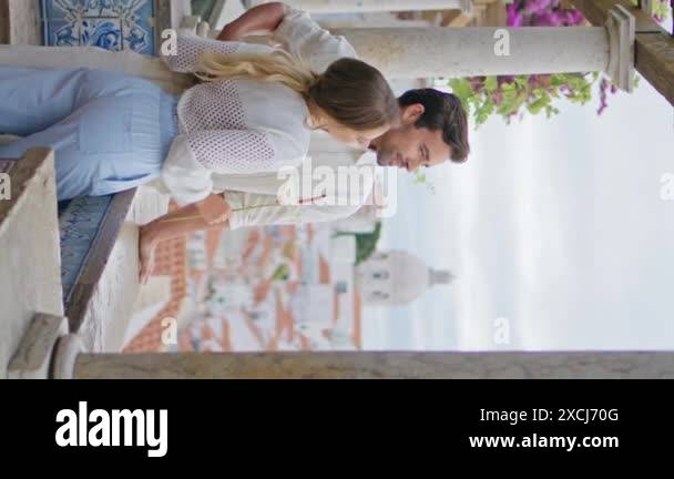 Affectionate couple standing city balcony admiring views vertically ...