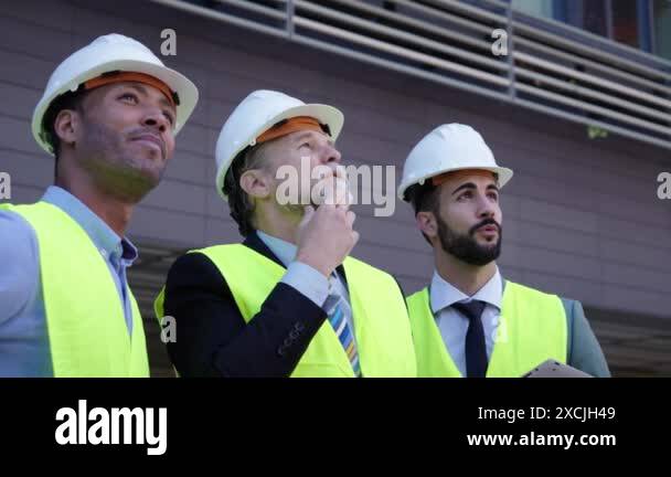 Real estate developers or technicians engineers looking upward in ...