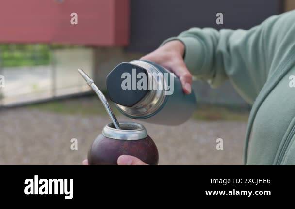 The process of preparing the South American drink yerba mate: a woman ...