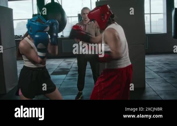 Medium full shot of two professional young female boxers or combat ...