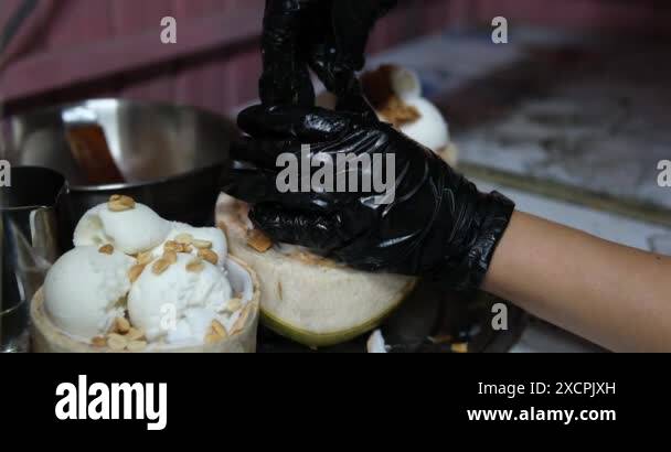 ice cream served in coconut, sprinkle with nuts, peanuts. High quality ...