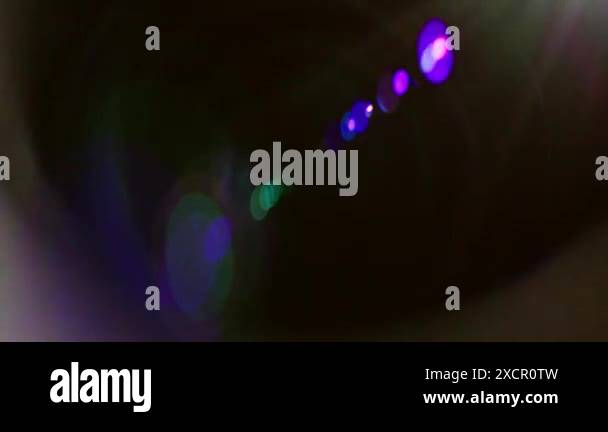 A striking display of colorful circular lens flares arranged in a row ...
