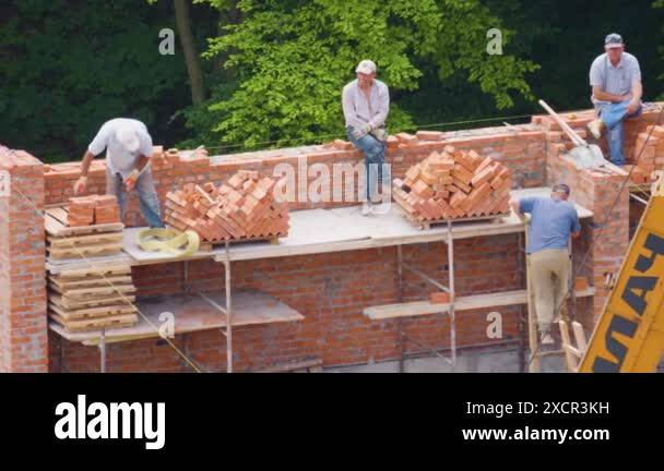 LVIV, UKRAINE - JUNE 2, 2024: Construction site. Builder workers are ...