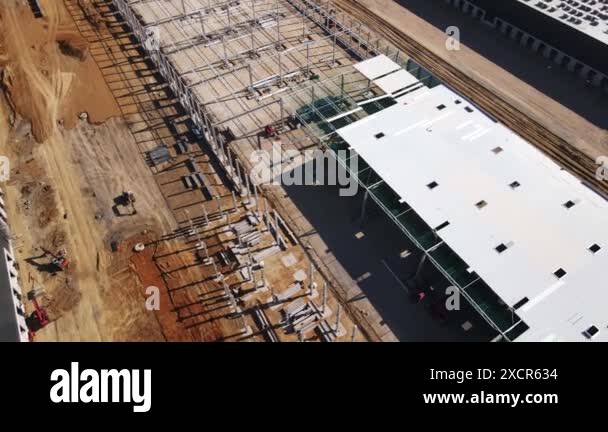 Aerial view of construction site with warehouse building under ...