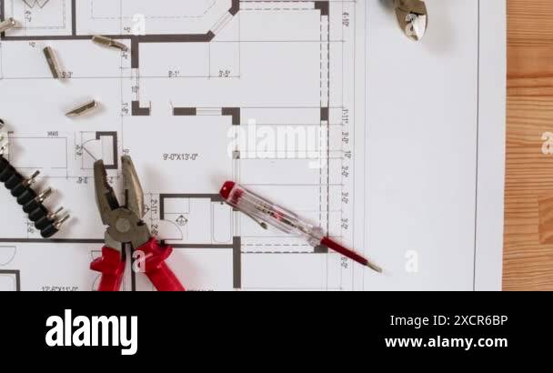 Putting hammer among tools near paper house on apartment drawing upper ...