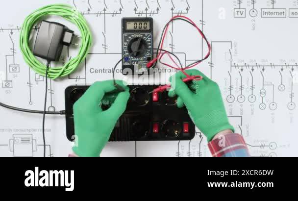 Technician tests socket extension with multimeter and plugs device on ...
