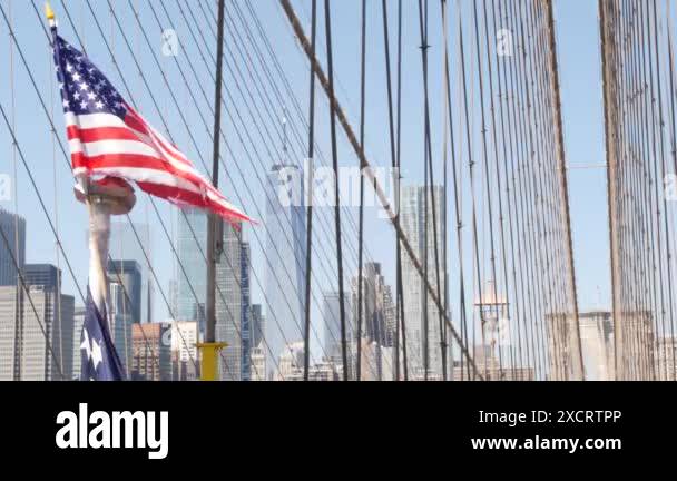 Flag on Brooklyn Bridge, Manhattan downtown, New York City skyline ...