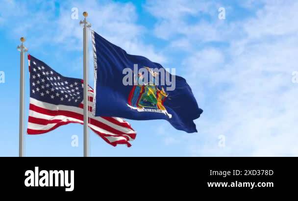 New York State flag waving with the American flag on a clear day. Blue ...
