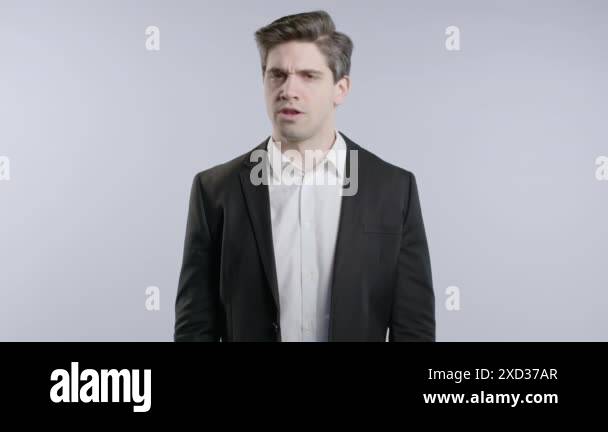 Serious businessman disapproving with no head sign, nods head ...