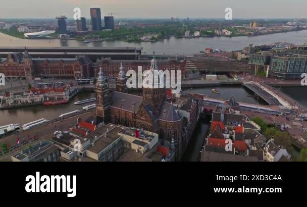 Drone shot Amsterdam summer cityscape narrow old houses, canals. Aerial view of famous places ...