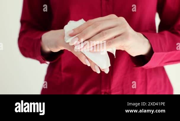 Woman wipes hands with disinfectant tissue for hygiene. Lady removes ...