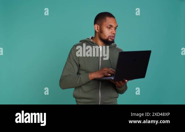 Man typing on laptop keyboard, checking emails, feeling overjoyed after ...