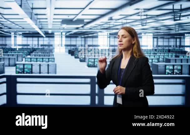 Software developer looking at holograms in data center, monitoring ...