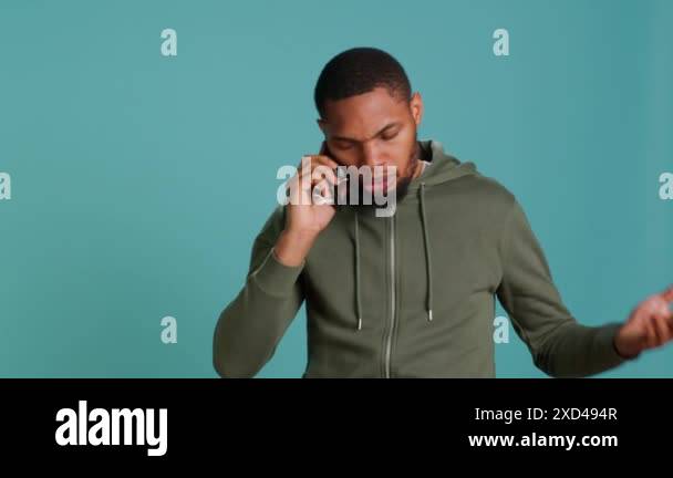 Irked african american man fighting with friends during telephone call ...