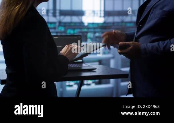Team of admins in server room location installing newly ordered storage unit, close up ...