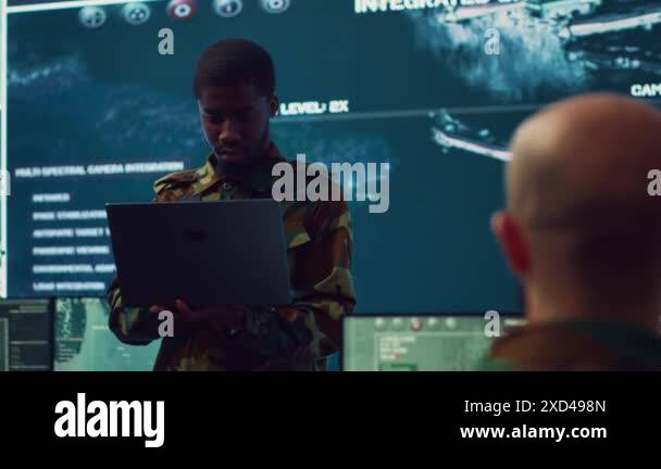 Infantry unit leader examines big data on a screen in military ...