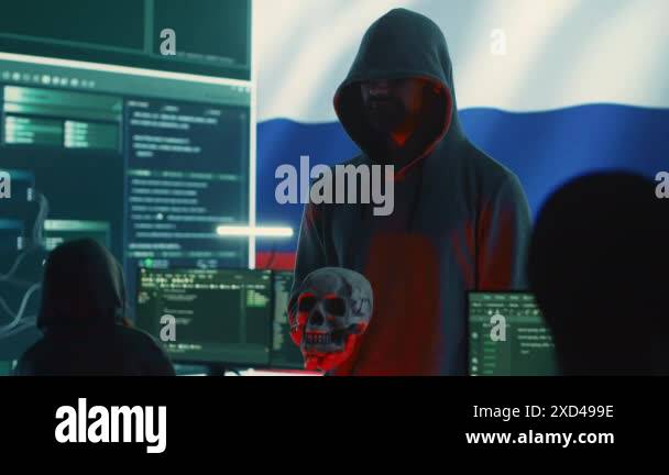 Digital outlaw hacker in a dark hood issuing cyber threats with a human ...