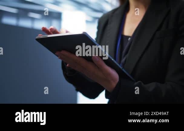 Programmer managing data center with advanced technology using digital device. Close up shot of ...