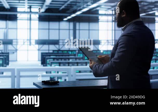 System administrator in server room establishment installing newly ordered storage unit ...