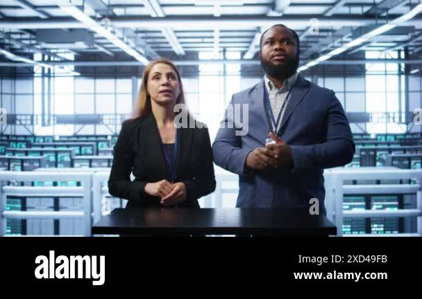 Admin and coworker looking at holograms in data center, doing swiping ...