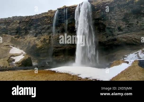 Seljalandsfoss, a picturesque waterfall in Iceland. The water cascades ...