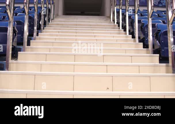 Stairs on an empty ice arena between sectors of spectator seats. empty ...