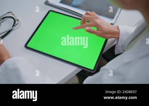Medic hand pointing chroma key tablet in polyclinic closeup. Unknown ...