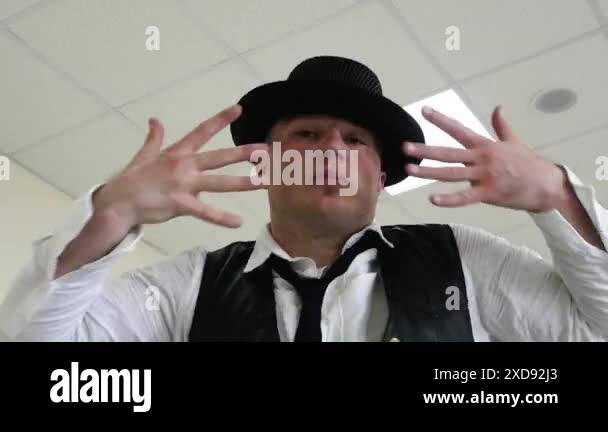 Gangster dance in a hat, jazzman dances by snapping his fingers ...