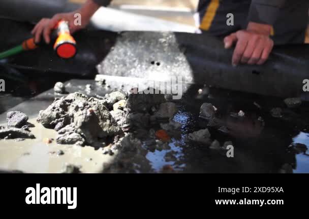 A workers hands hold amber pebbles mined at the excavation site and ...