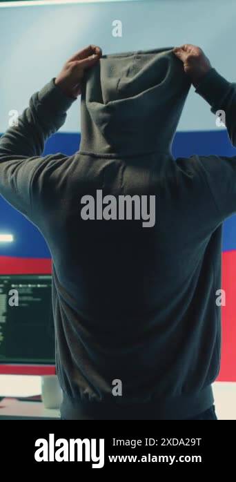 Vertical Video Russian hacker with a hood installing panic by ...