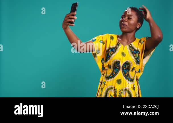 Female model being excited and happy on her pictures in studio, taking photos with confidence ...