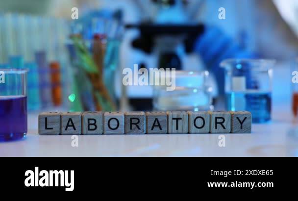 Word Laboratory of wooden blocks against chemist working with ...