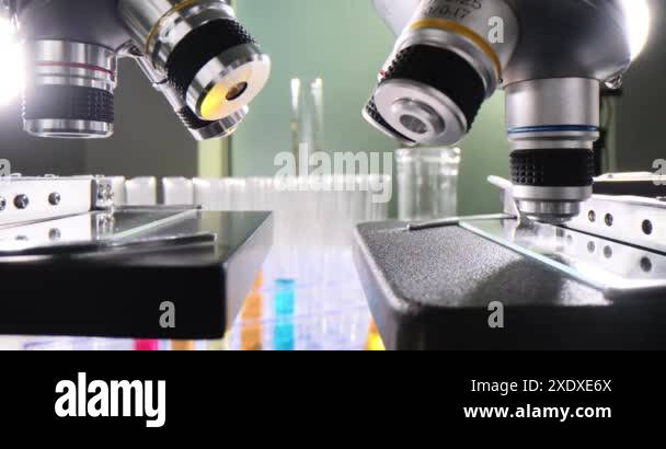 Microscopes with interchangeable lenses stand in laboratory. Modern ...