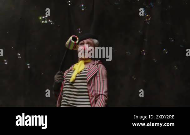 Medium shot of male Caucasian male circus artist wearing clowns outfit ...