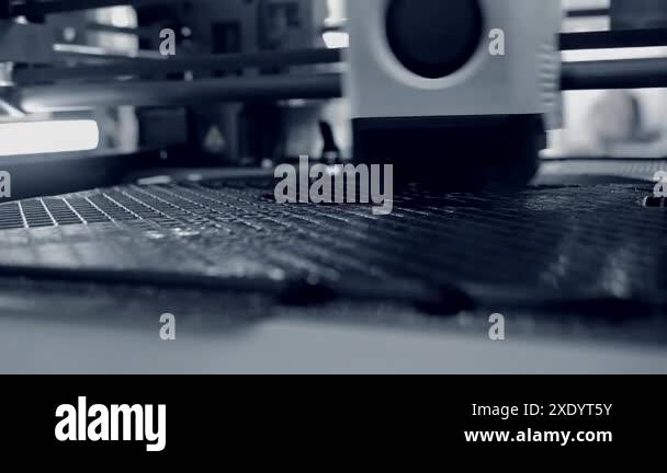 3D printer close up. A working 3D printer in process of printing object ...