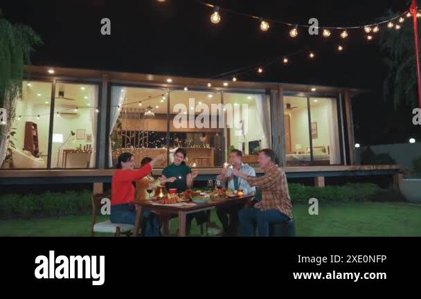 Happy family holding glowing sparkler in holiday celebration party at ...