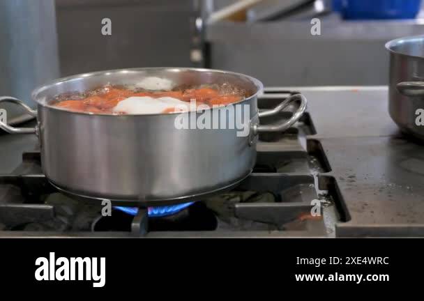 Close up view of casseroles at a commercial kitchen. Preparing and ...