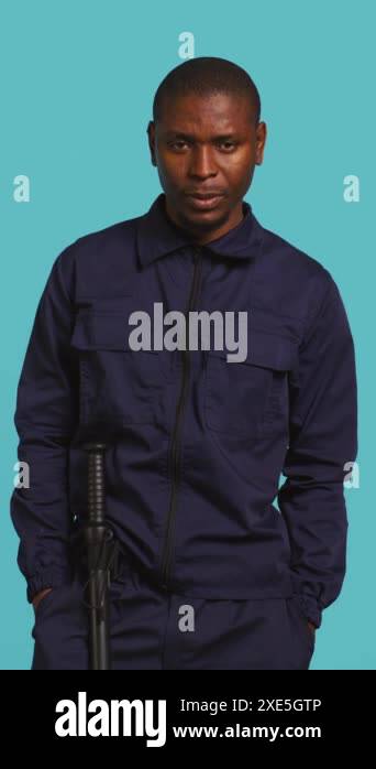 Vertical video Bored security guard preventing criminal activity ...