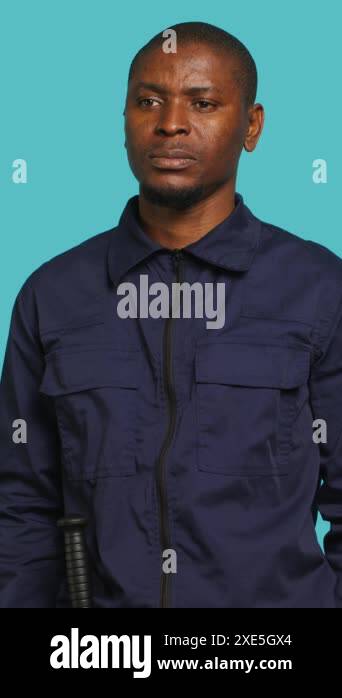 Vertical video Smiling security guard saluting people during ...