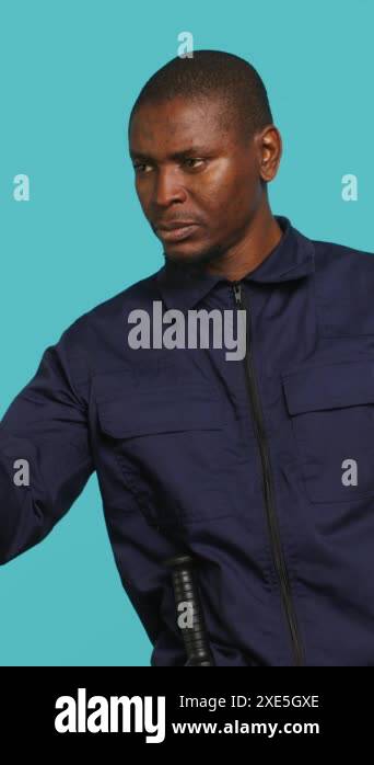 Vertical video Portrait of security agent pointing finger at people ...